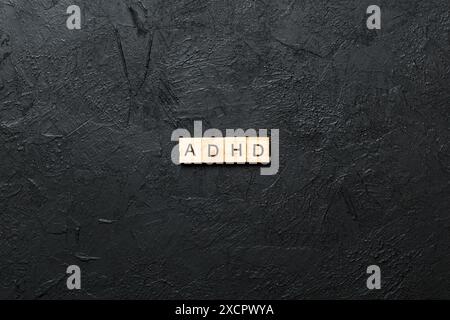 ADHD word written on wood block. ADHD text on table, concept Stock ...