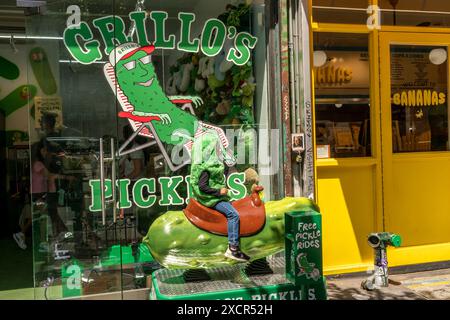 A child dressed as a pickle takes a ride on a pickle at the GrilloÕs ...