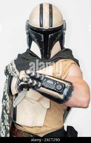 A male cosplayer dressed as a Star Wars character Mandalorian at Comic ...