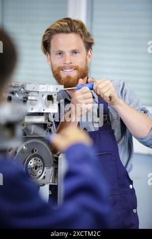 the working hands of a white man,a man screws a nut to a metal ...