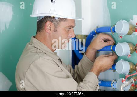 a man is fixing a water meter Stock Photo - Alamy