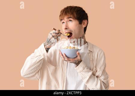 Man eating cereal rings on white background Stock Photo - Alamy