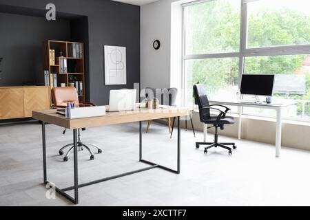 Interior of office with desks, shelf unit and shredder Stock Photo - Alamy