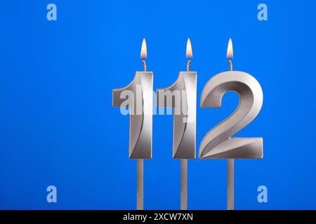 Lit birthday candle - Candle number 112 on white background Stock Photo ...