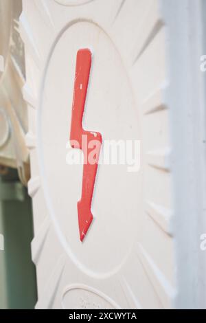 Two electrical boxes with lightning bolt on brick wall Stock Photo - Alamy