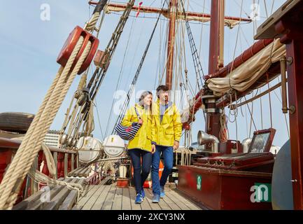 Couple outside a sailboat, galleon. Masts. Basque Country. Spain Stock ...