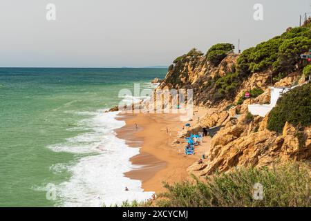 Roca Pins beach in Calella. A picturesque beach between the rocks ...