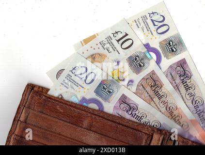 A leather wallet and modern polymer banknotes from the United Kingdom ...