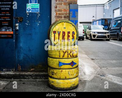 STACK OF YELLOW WITH BLUE ARROW TYRES TIRE RUBBER FOR AUTOMOTIVE ...