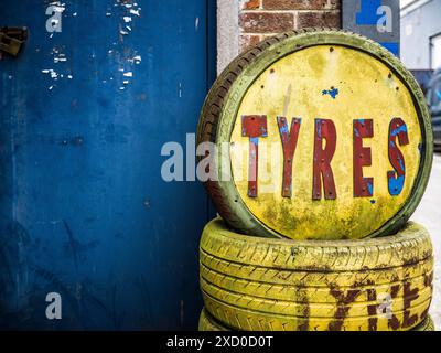 STACK OF YELLOW WITH BLUE ARROW TYRES TIRE RUBBER FOR AUTOMOTIVE ...