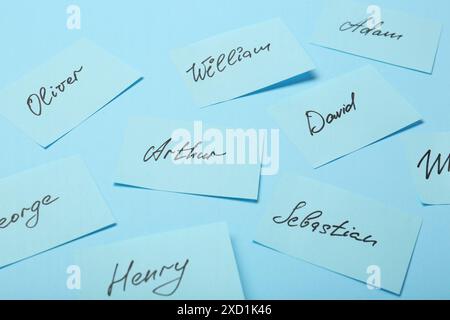 Paper stickers with different names on wooden background. Concept of ...
