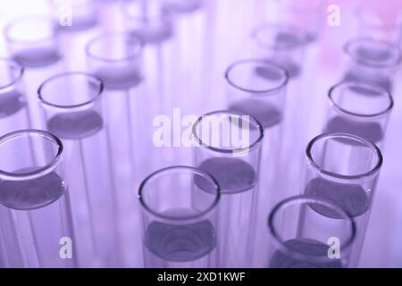 Test tubes on violet background Stock Photo - Alamy