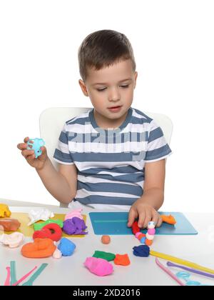 Little boy sculpting with play dough at table on white background Stock ...