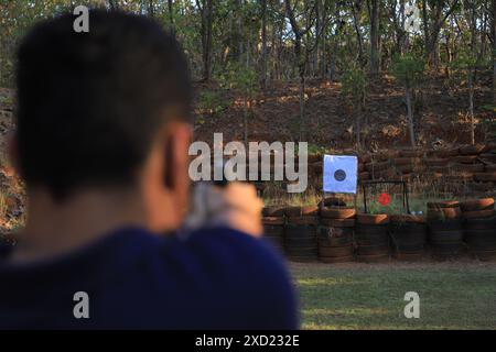 A man aims and fires a gun at the shooting range Stock Photo - Alamy