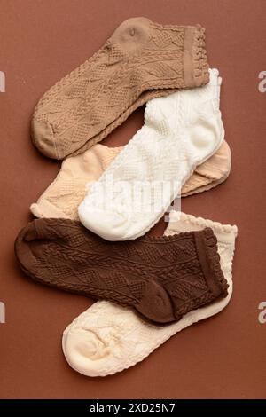 Different basic color socks on brown background Stock Photo - Alamy