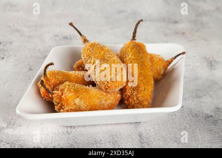 Breaded chilli poppers with chicken filling and cheese sauce Stock ...