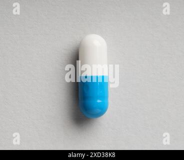 One antibiotic pill on grey background, top view. Medicinal treatment ...