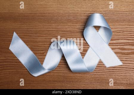 International Psoriasis Day. Ribbon as symbol of support on wooden ...