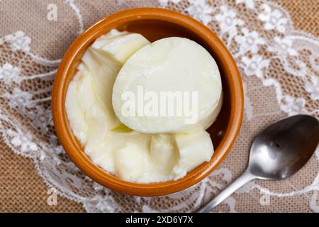 Clay pot contains fresh fermented milk curd with honey closeup Stock ...