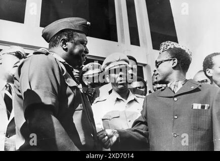 Uganda's President Idi Amin, centre, wearing boxing gloves, squares up ...