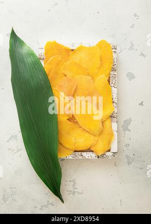 Slices of large sweet dried mangoes in wooden box.Top view Stock Photo ...