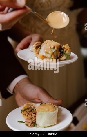Professional chef plating elegant appetizers in a commercial kitchen ...