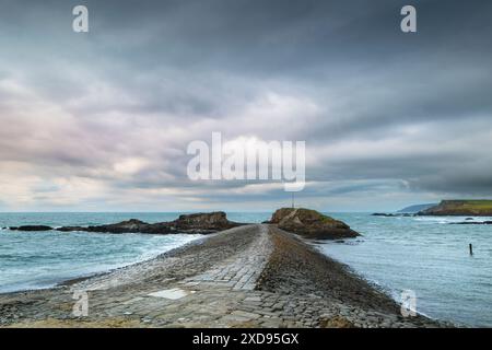 The historic breakwater levee leading to Chapel Rock on the coast of ...