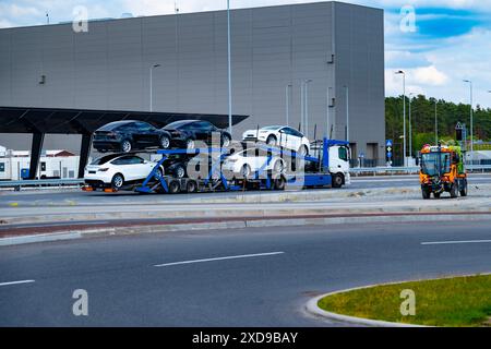 semi-truck transports loaded new Tesla vehicles leaving Gigafactory ...