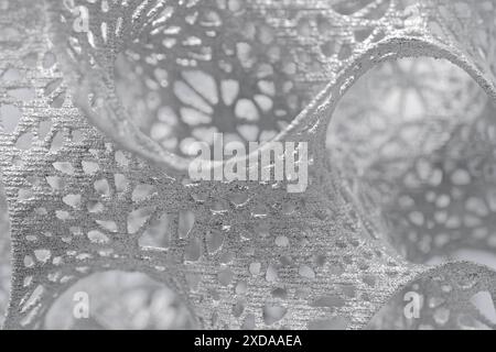 3D-printed white lacy grid, three-dimensional openwork lattice close up ...