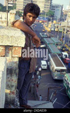 Indian Men with view of traffic with cars, bus amd motorcycle on a ...