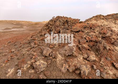 Burnt volcanic red rock near the mud volcanoes near the village of ...