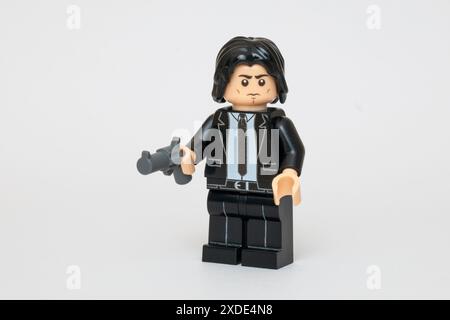 A Lego minifigure dressed in a black suit holding a weapon Stock Photo ...