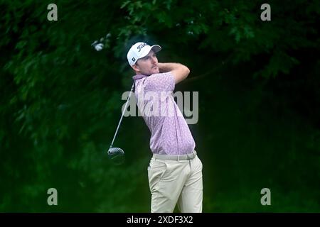 Russell Henley watches his tee shot on the 12th hole during the first ...