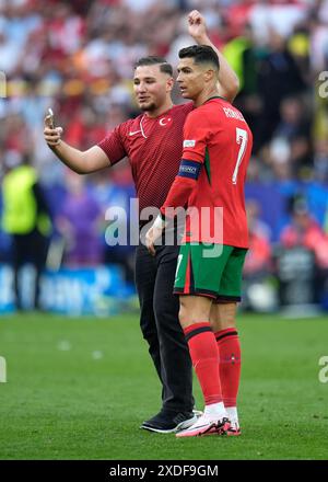 A third pitch invader attempts to get a photo with Portugal's Cristiano ...