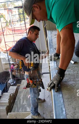 Mexican construction workers finishing interior house Stock Photo - Alamy