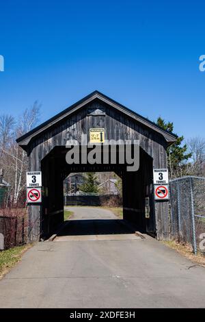 Entrance to the wooden covered bridge at the wharf village at Magnetic ...