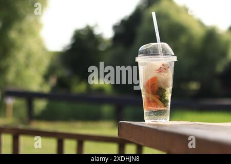 Plastic disposable cup with trash inside, close-up. Improper disposal ...
