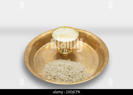 A copper plate and bowl of Dahi Chiura aka Yoghurt and Rice Flakes for ...