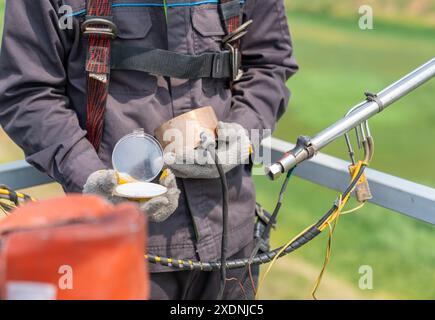 Environment officer sampling pipe for sampling air in stack of boiler ...