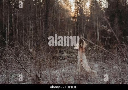 Woman in a dress twirling in the morning sun in nature Stock Photo - Alamy