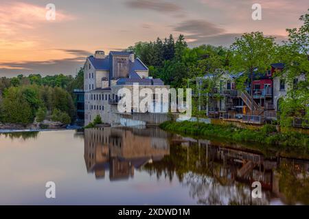 The historic Elora Mill, nestled in a gorge, overlooks the Grand River ...