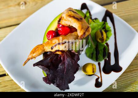 Tasty fried legs of quail served with vegetables and balsamic pasta ...