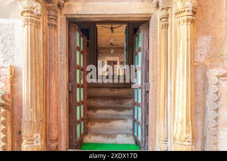 India, Uttar Pradesh, Mughalsarai, Bangali Tola. Men sitting on steps ...