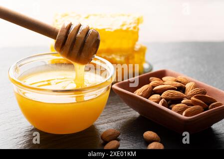 Honeycomb on slate tray with honey and nuts on kitchen table Stock ...