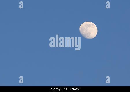 Full moon in clear dark blue night sky Stock Photo - Alamy