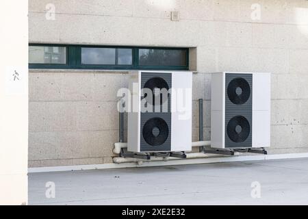 Air conditioner compressor units installed outside of a building Stock ...
