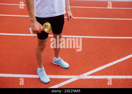 A determined athlete is in a crouched position at the starting line of ...