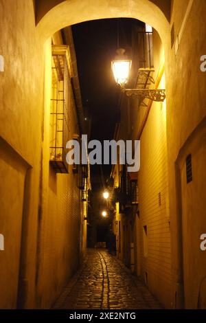 Narrow street in Seville at night, Spain Stock Photo - Alamy