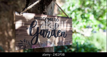 Garden welcome sign with mediterranean courtyard as background. English ...