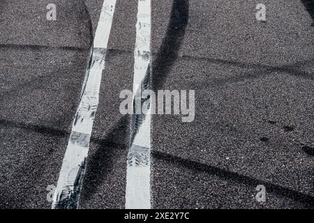 Black rubber tire marks in a street Stock Photo - Alamy